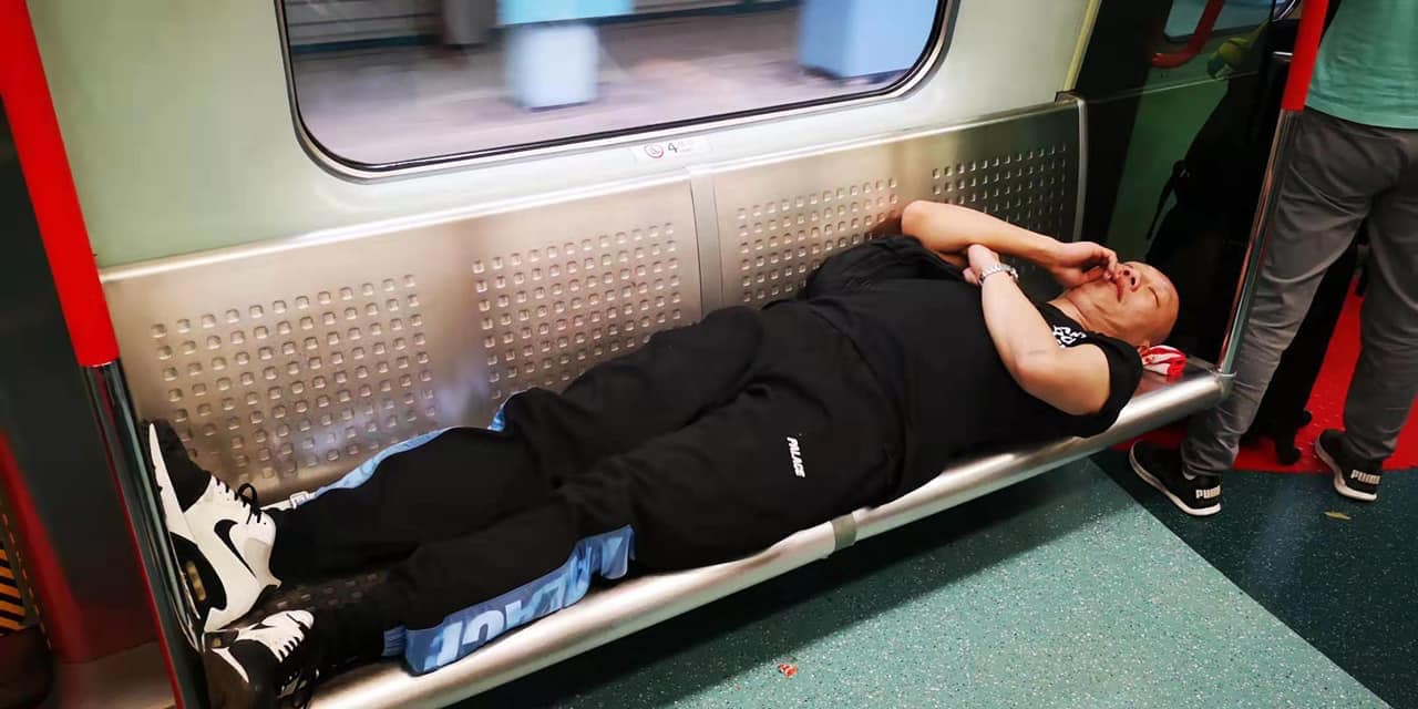 Man occupies multiple seats on MTR East Rail Line to sleep - Dimsum Daily