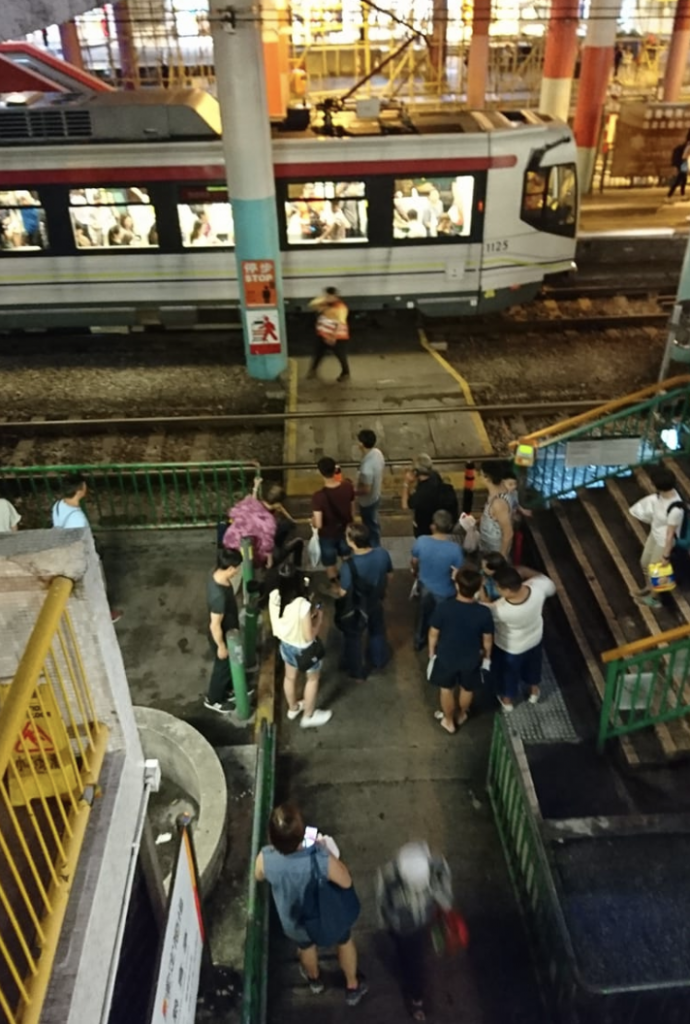 MTR Light Rail train stops after a pedestrian falls down and sustains ...