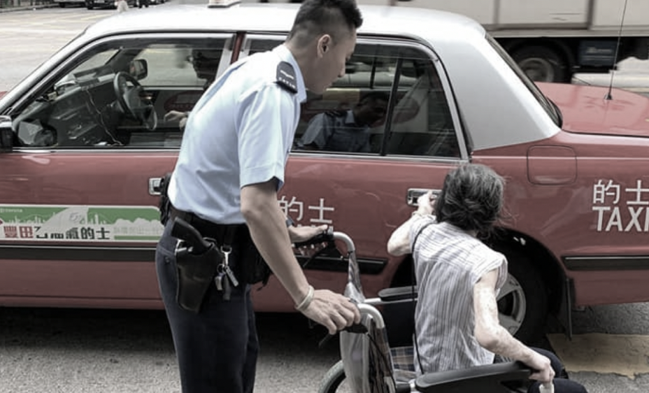 Police officer helps a handicapped elderly woman to get a taxi home in ...
