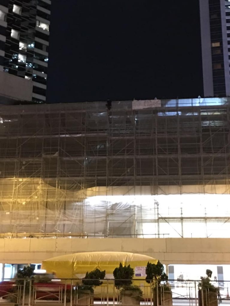 Man stands precariously on the rooftop of Pacific Place in Admiralty ...
