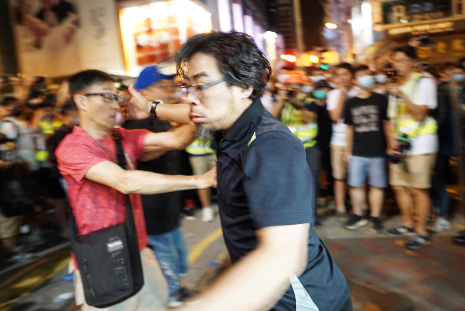 Man runs amok and assaults several other protestors under the watchful ...