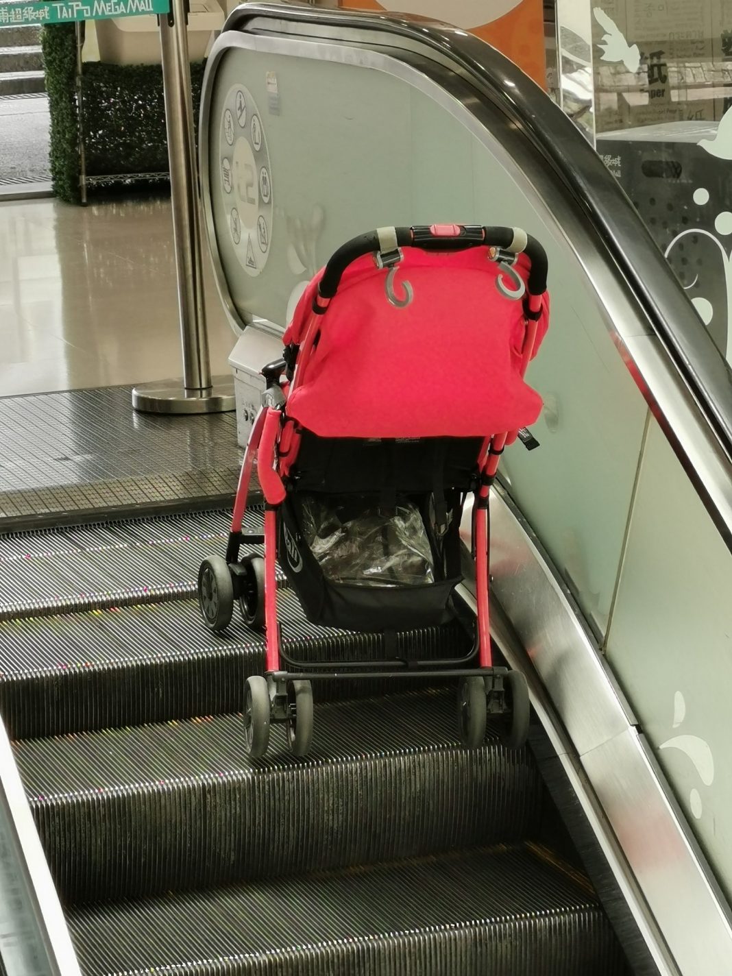 Baby stroller stranded and jammed on the escalator in Tai Po Mega Mall ...