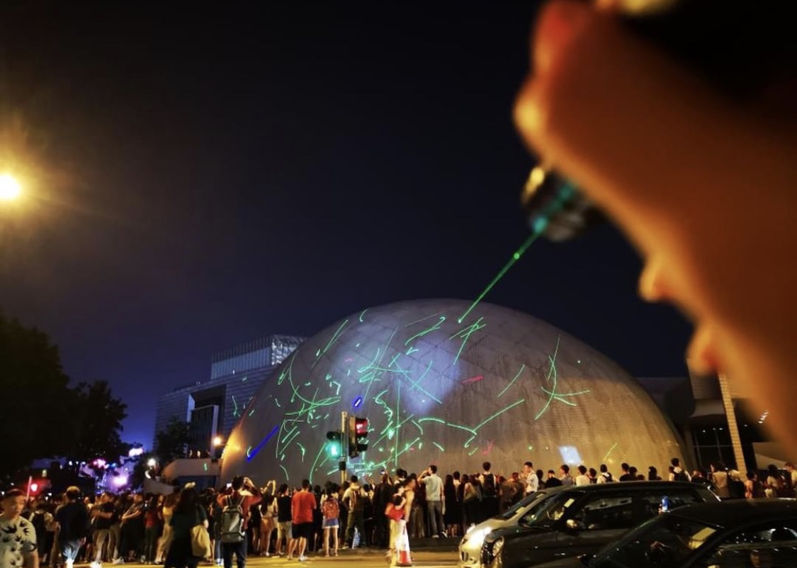 Hundreds of protesters flash laser pointers at the dome shaped science ...