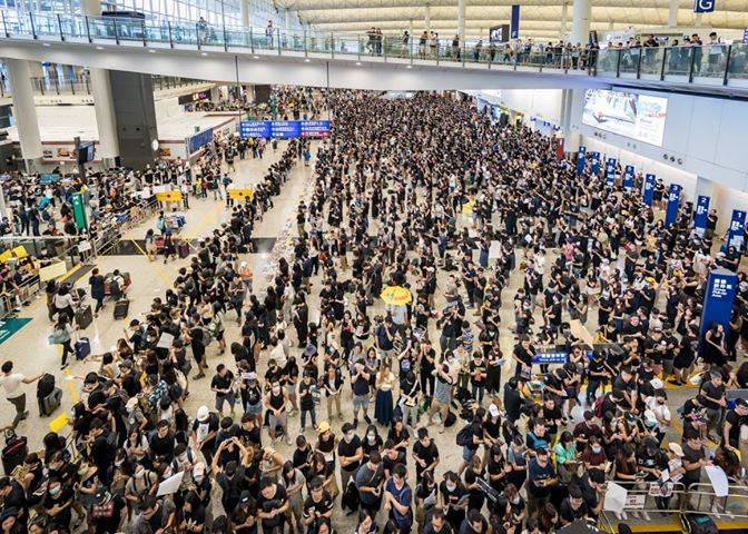 Less than 50 protesters greet travellers at Arrival Hall B this morning ...