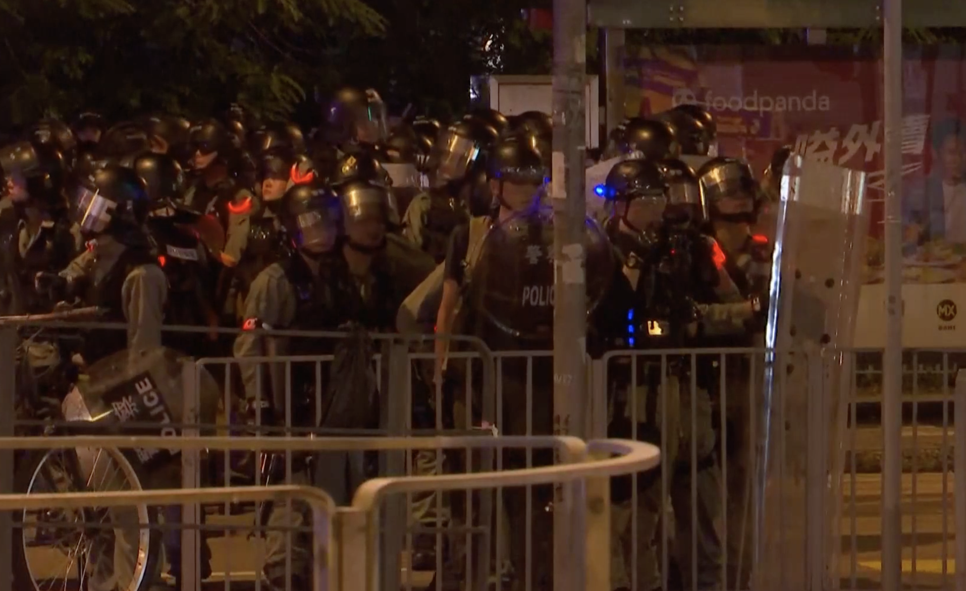 Riot police hoist blue flags twice as protester barricade Kau Hui Road ...