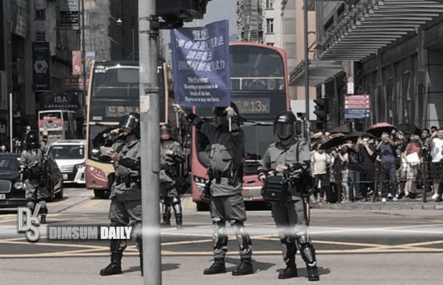 Riot police hoist blue flag in front of SOGO TST while thousands make ...
