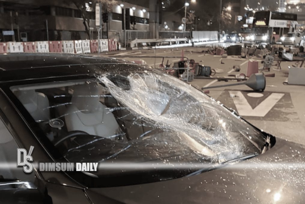 Rioters smash a Tesla after the driver attempts to clear obstacles ...
