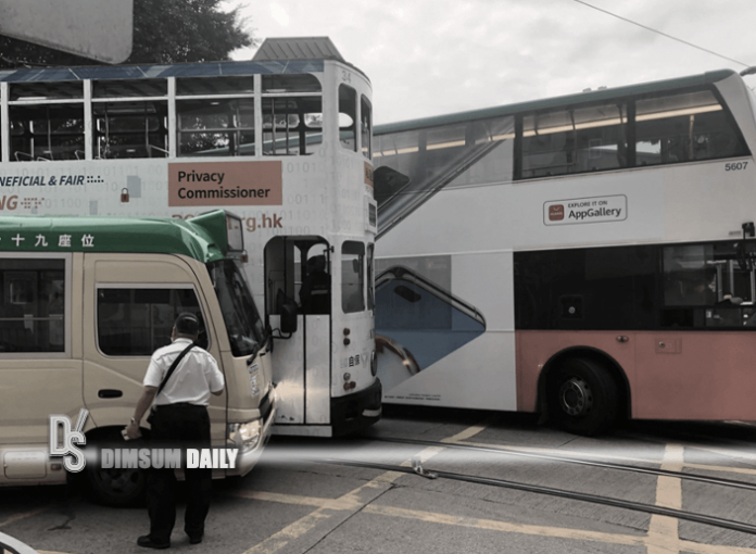 Tram sandwiched between bus and minibus in Kennedy Town - Dimsum Daily