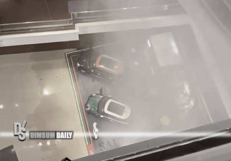 Mini Cooper rides on malfunctioned fire sprinkler system during ...