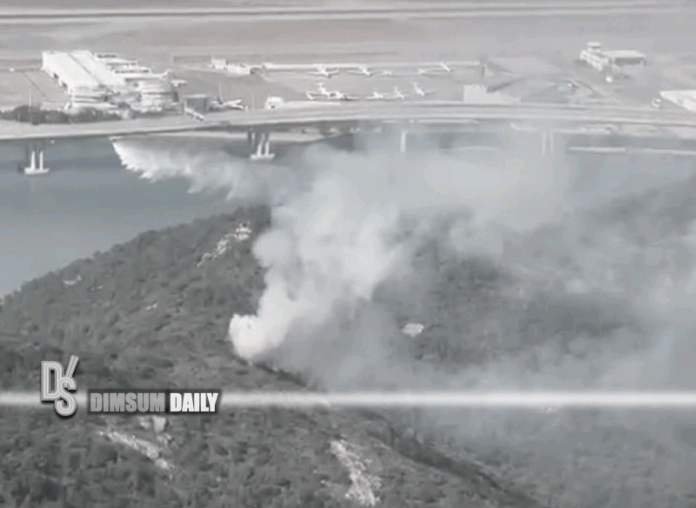 Wildfire spotted on the hilltop opposite Hau Hok Wan on Lantau island ...