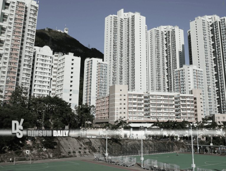 Man stands precariously at the window of a unit in Ching Tai House in ...