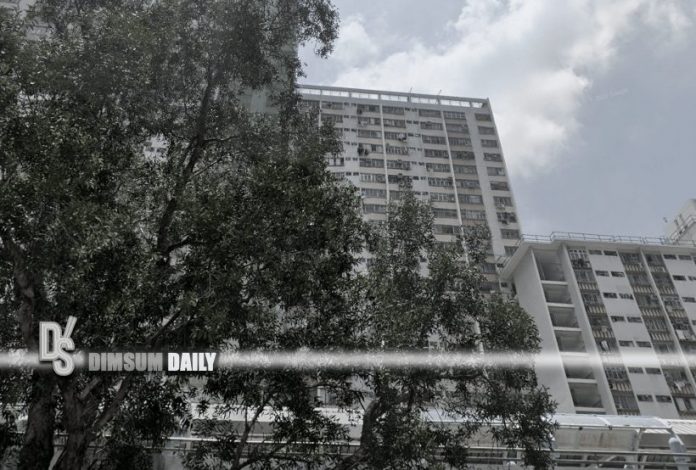 Man sits precariously at edge of corridor at Koon Yat House, Choi Wan ...