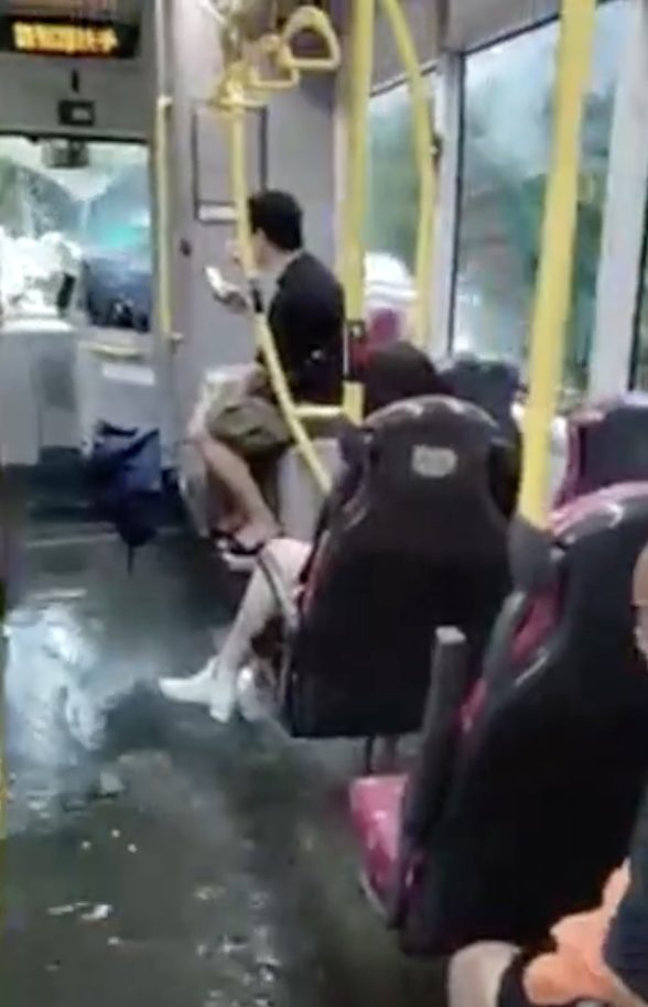 Bus submerged in flood water in Yuen Long while passengers continue to ...