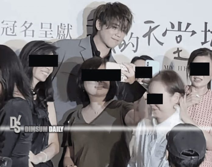 MIRROR member Keung To surrounded by fans for a group photo during ...