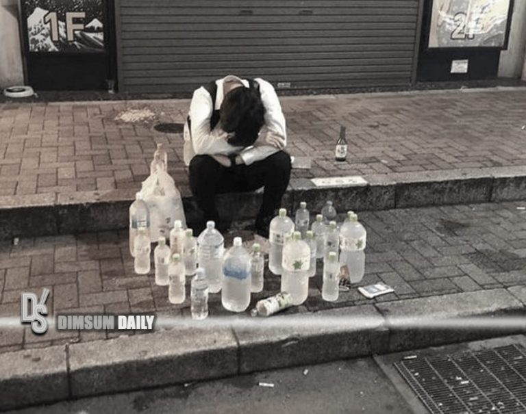 Picture of drunk man with mineral water bottles placed around him in ...