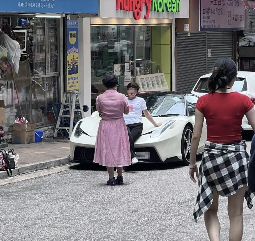 Four middle-aged women surround Ferrari in Tsim Sha Tsui - Dimsum Daily