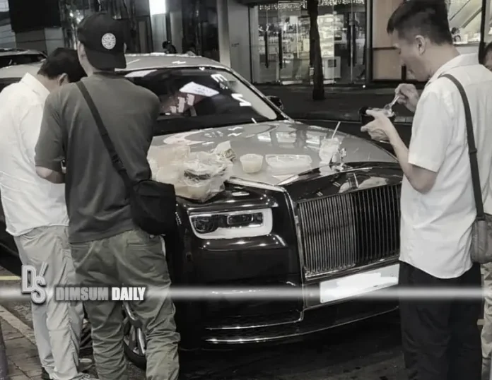 Netizens debate image of men eating takeaway food by Rolls Royce ...
