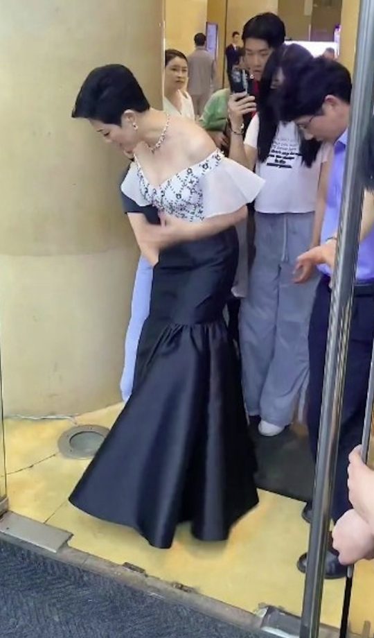 57-year-old Monica Chan, former Hong Kong beauty queen, startled as low-cut dress slips at event