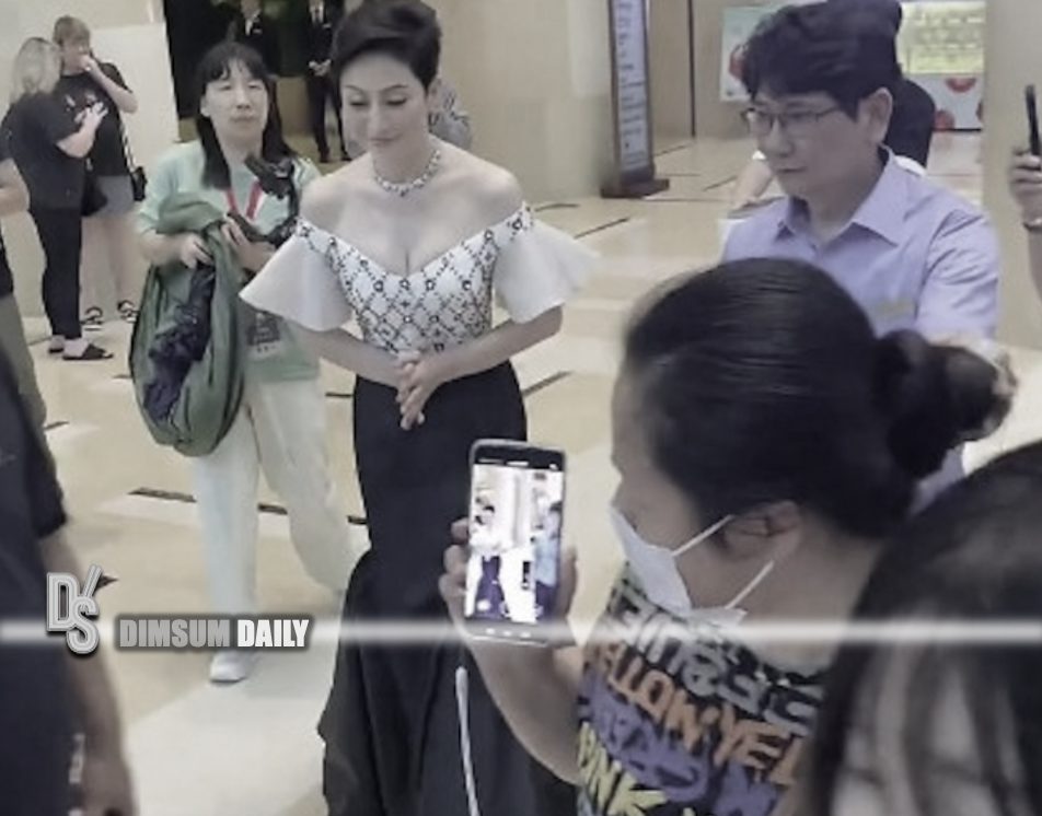 57-year-old Monica Chan, former Hong Kong beauty queen, startled as low-cut dress slips at event