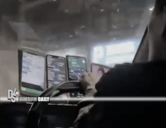Viral video captures taxi driver distracted by multiple phones, one ...