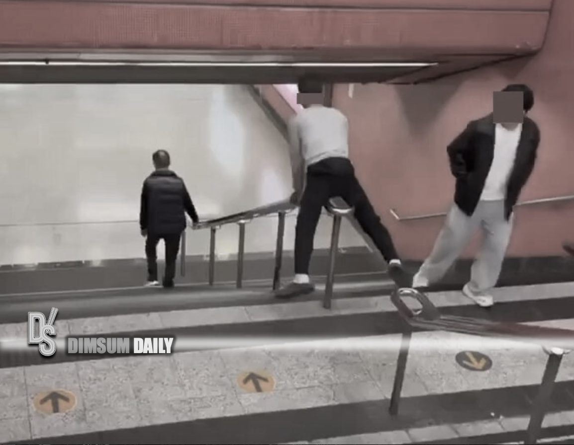 Man spotted sliding down handrail of staircase at MTR station