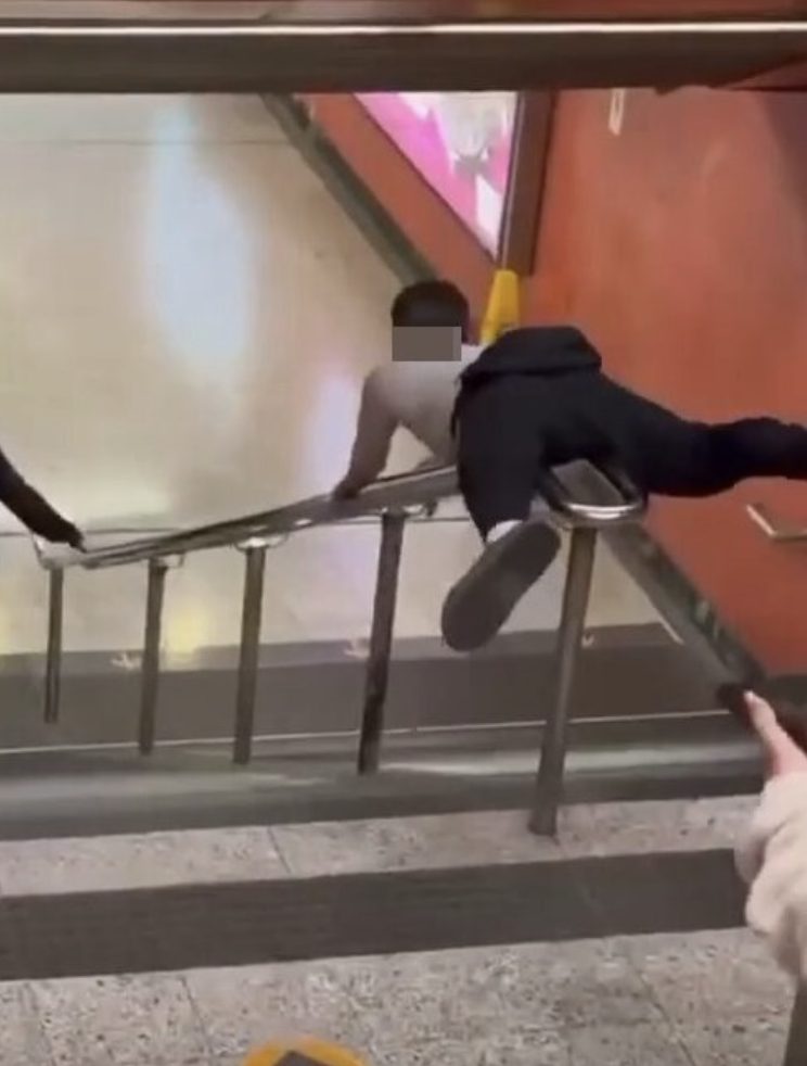 Man spotted sliding down handrail of staircase at MTR station