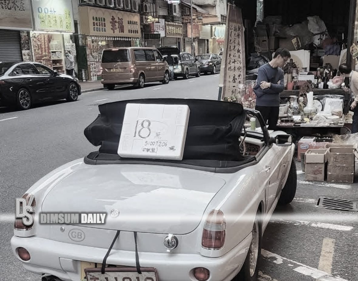 Truck-based car boot sale in Sham Shui Po showcases vintage MG convertible
