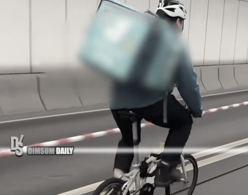 Video surfaces of Deliveroo rider cycling through road tunnel
