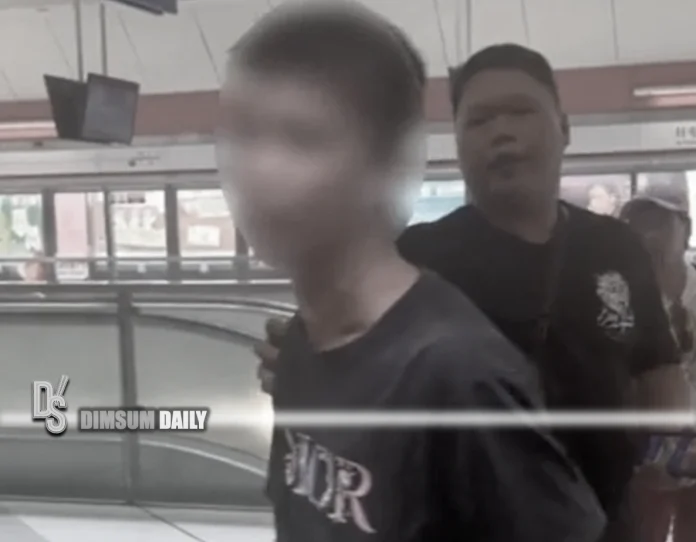 Man in black shirt shouts at passengers at MTR Long Ping Station ...