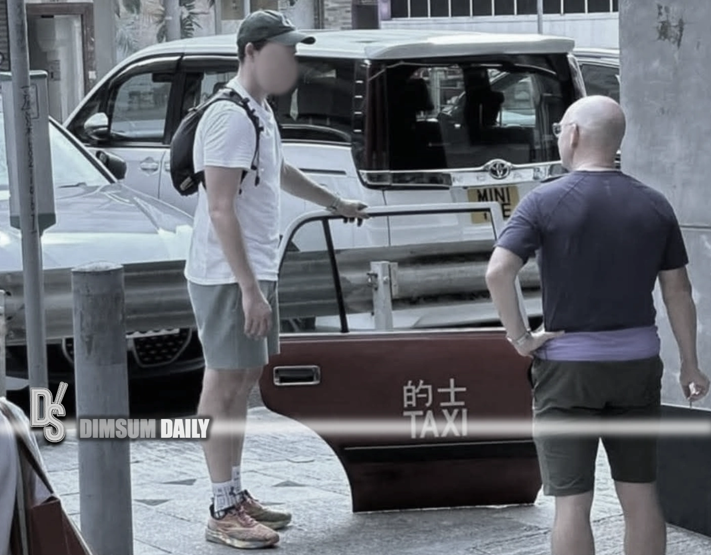 Foreign man poses with taxi door in Tai Hang