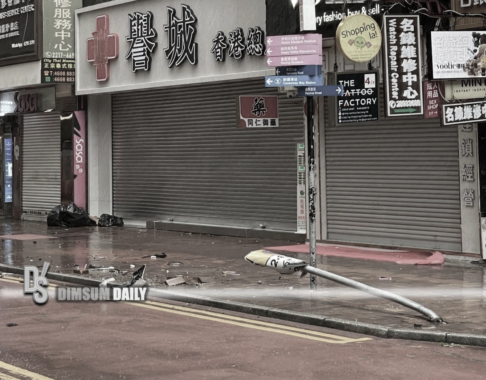 Road sign toppled by strong winds in Causeway Bay during Typhoon 8