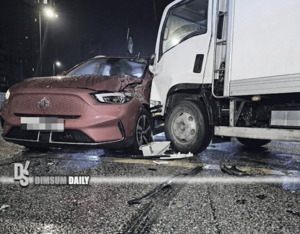 Three injured as refrigerated truck T‑bones car on rain‑slicked Tai Po road