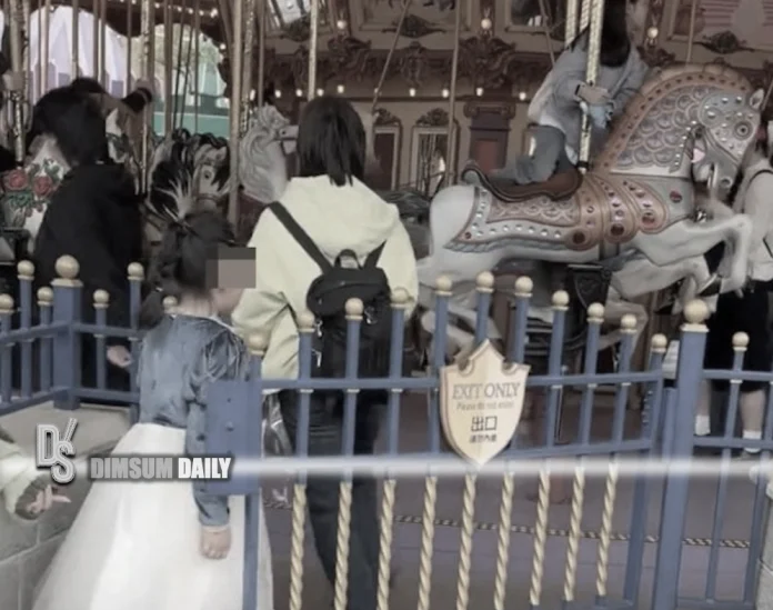 Mother and daughter use exit gate to access Cinderella Carousel at Hong ...